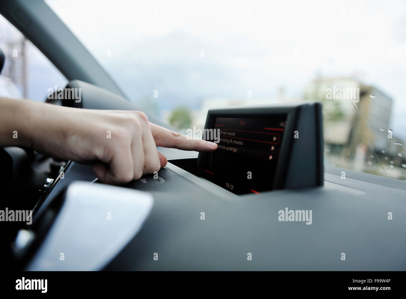 young man using new car navigation and onboard vehicle transport system ...