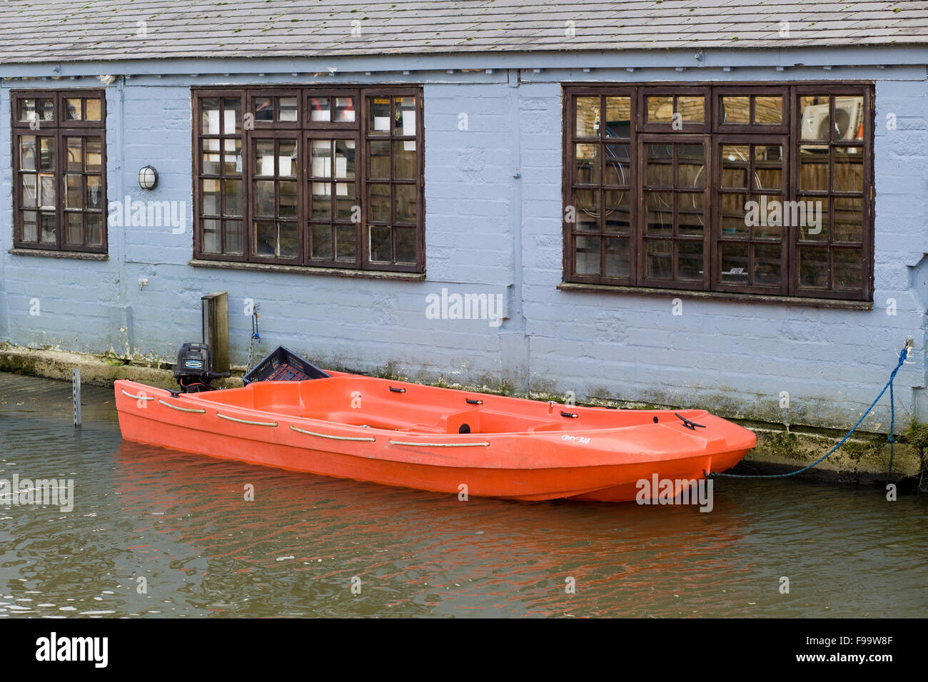 Motorized dingy moored outside a boat shop Stock Photo - Alamy