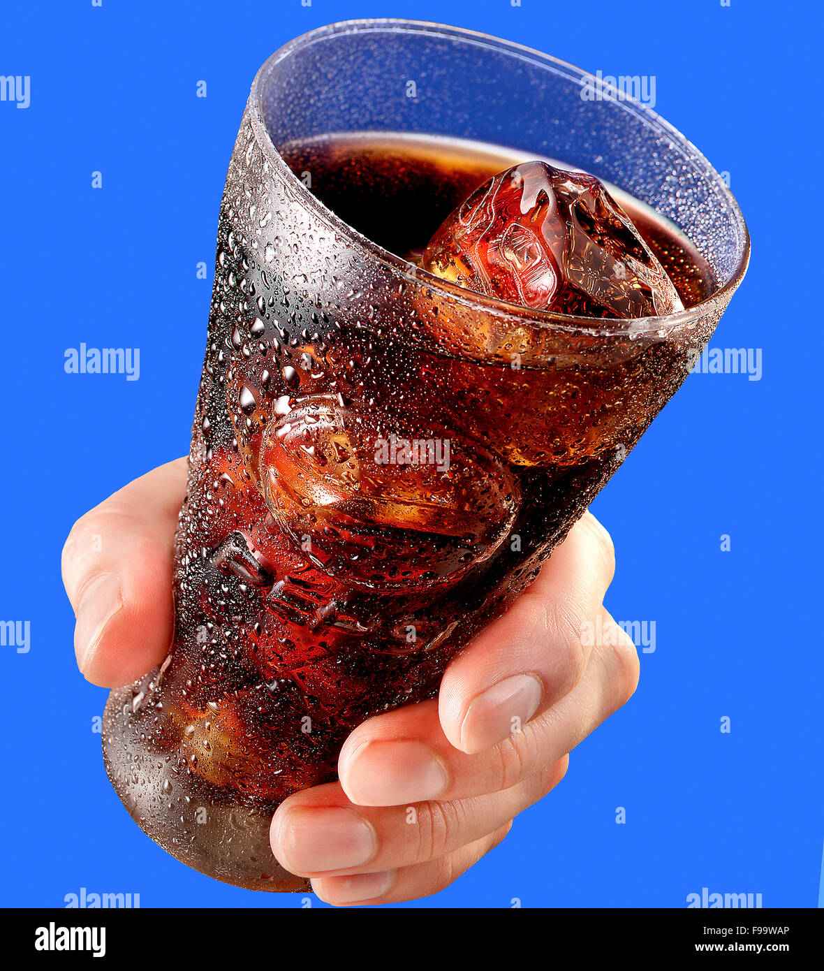 Hand holding a coke Stock Photo - Alamy