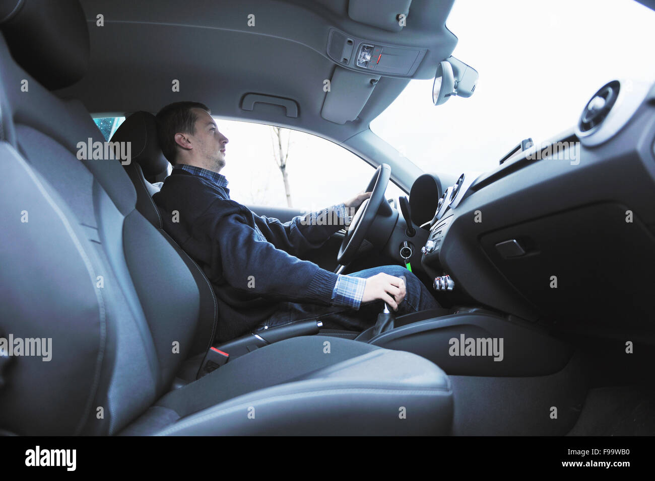 young man using new car navigation and onboard vehicle transport system ...