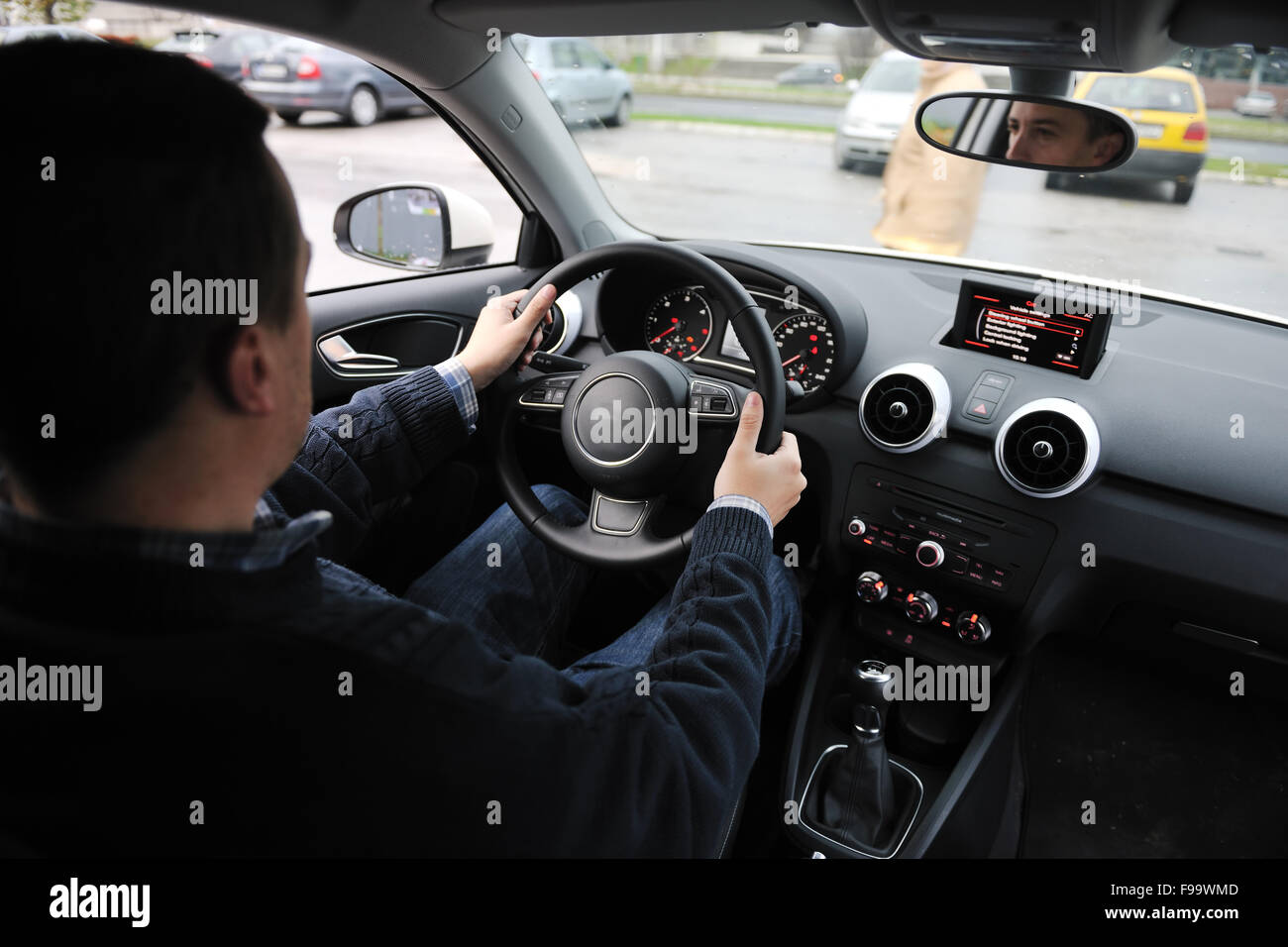 young man using new car navigation and onboard vehicle transport system ...