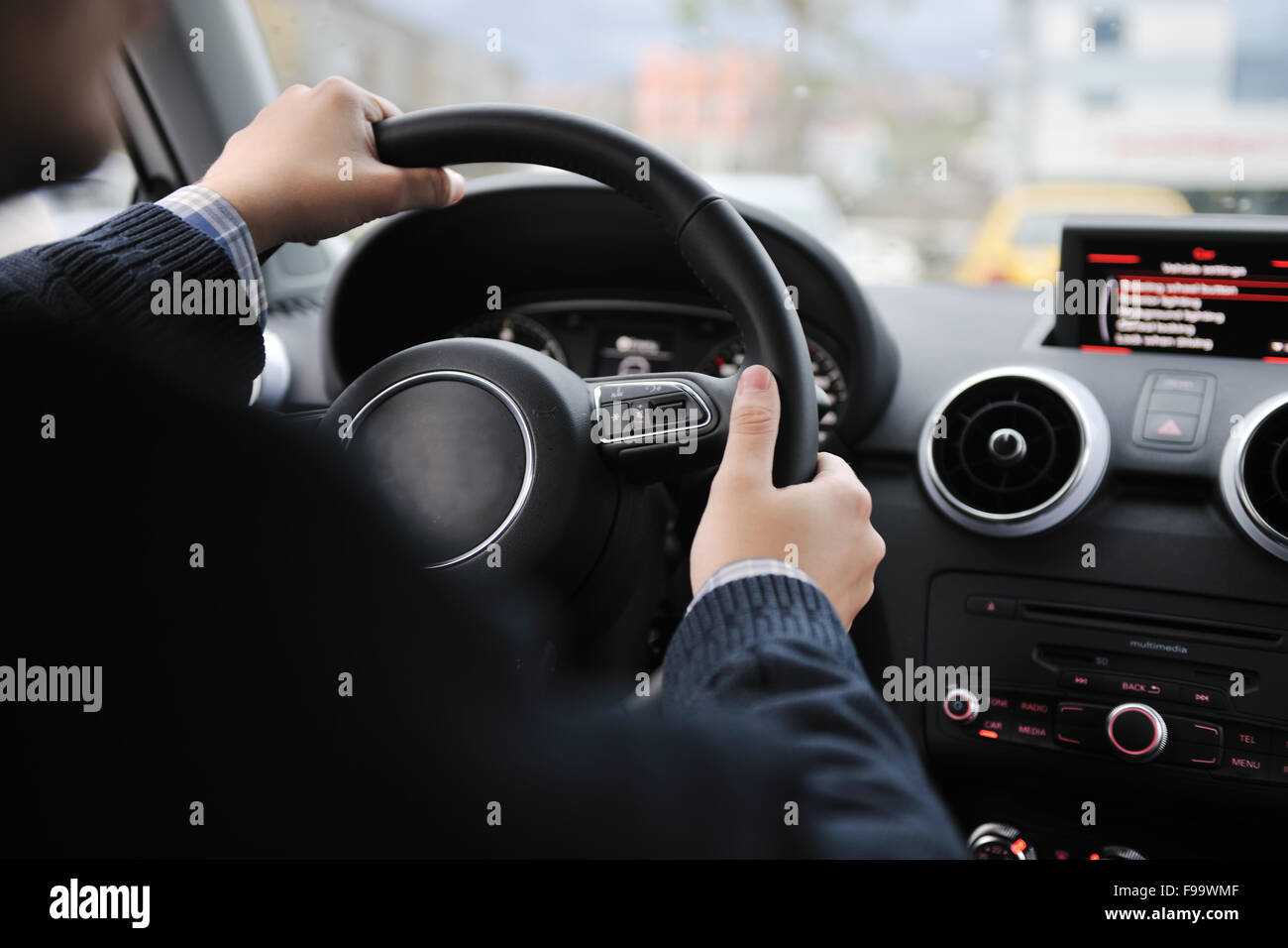 young man using new car navigation and onboard vehicle transport system ...