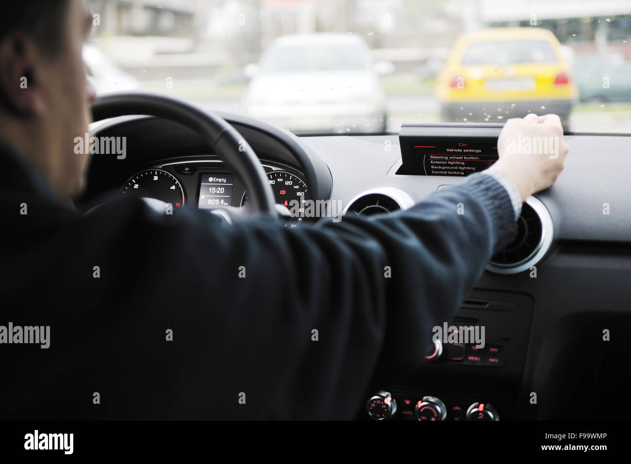 young man using new car navigation and onboard vehicle transport system ...