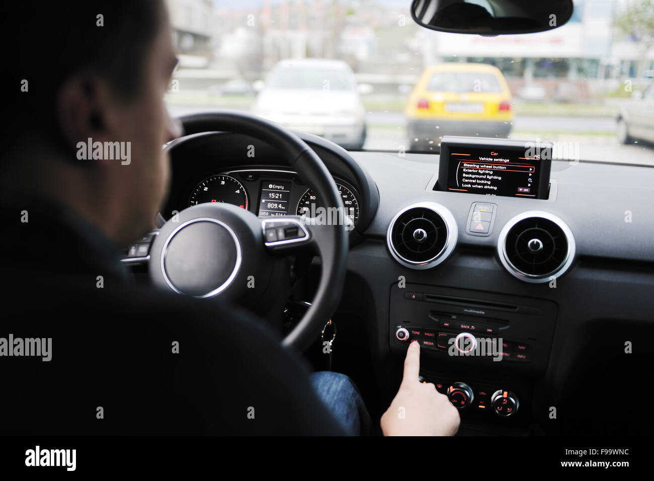 young man using new car navigation and onboard vehicle transport system ...