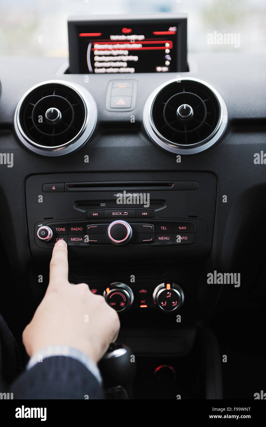 young man using new car navigation and onboard vehicle transport system ...