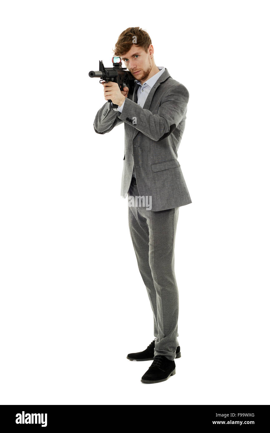 Handsome caucasian guy aiming the machine gun at invisible target ...