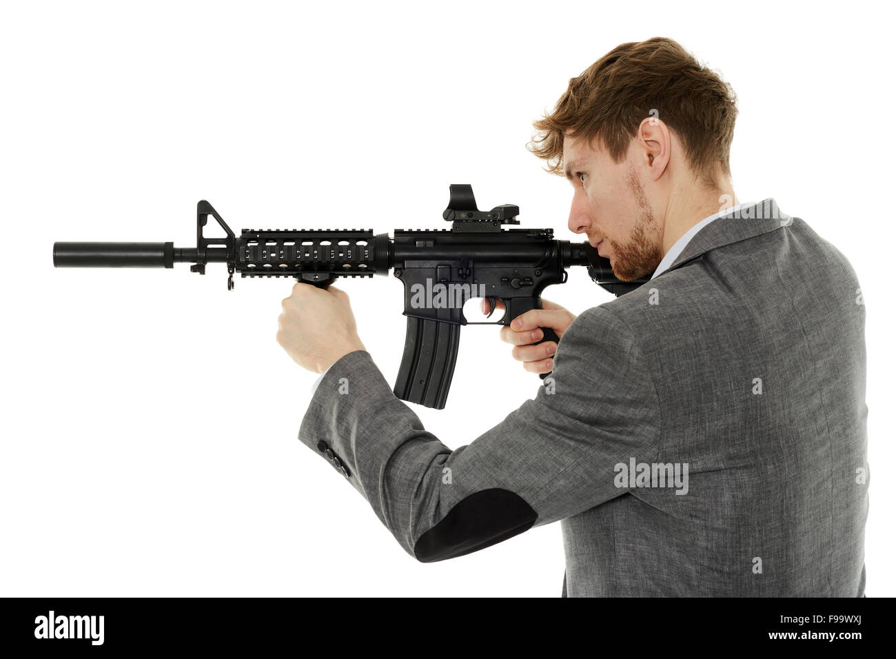 Handsome caucasian guy aiming the machine gun at invisible target ...