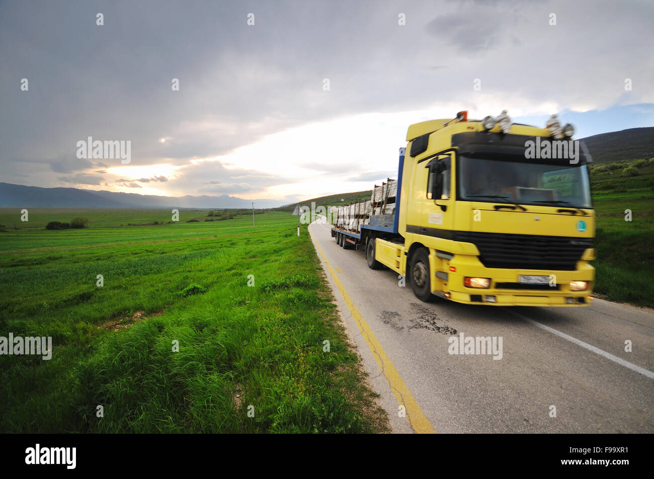 big truck drive on long country road Stock Photo - Alamy