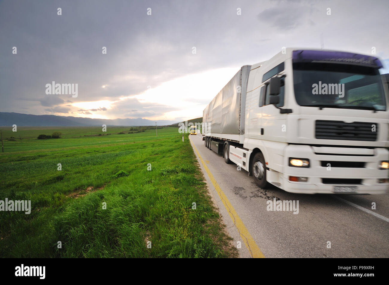 big truck drive on long country road Stock Photo - Alamy