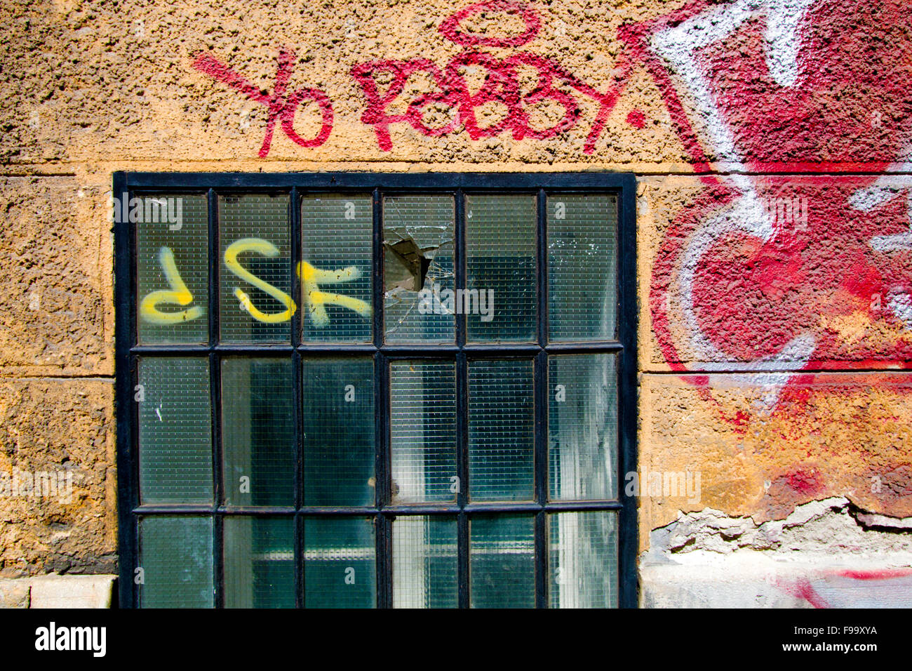 Graffiti wall with a smashed window Stock Photo - Alamy