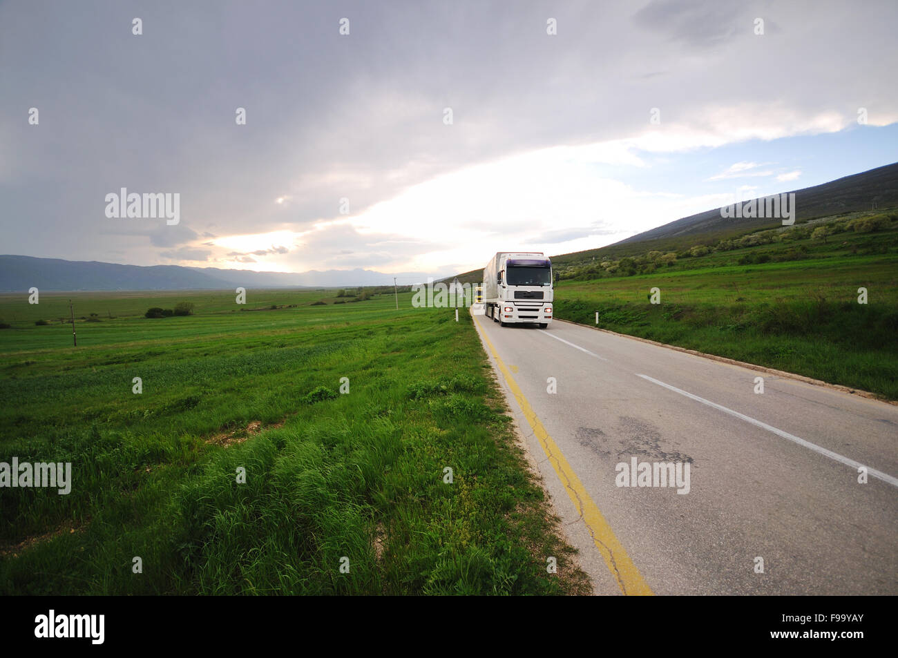 big truck drive on long country road Stock Photo - Alamy