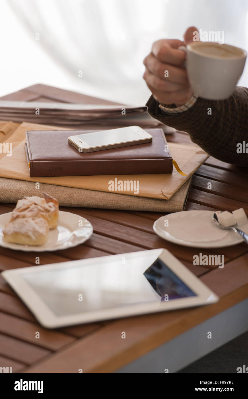 Young businessman on a coffee break. Using tablet computer Stock Photo ...