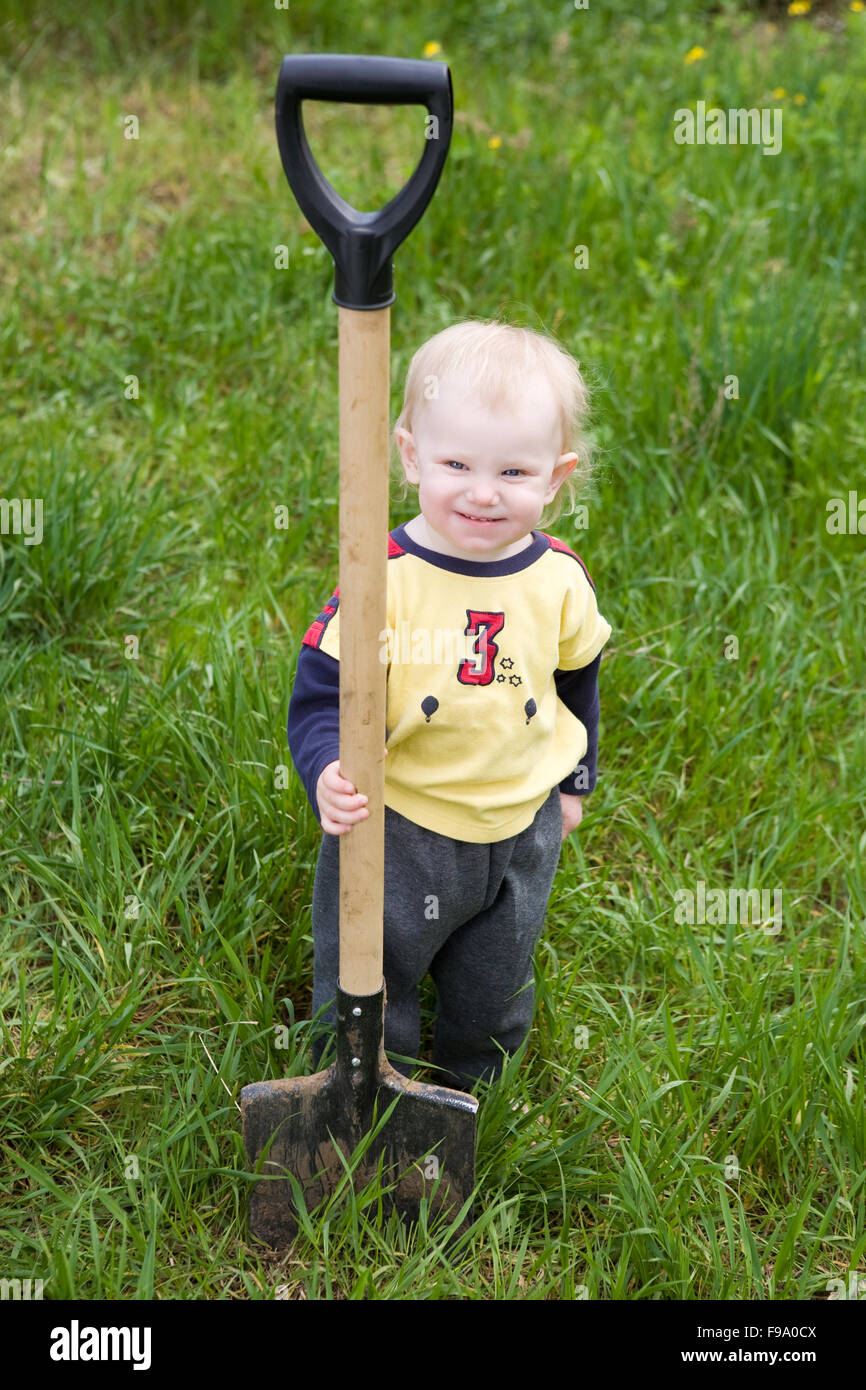 child with the shovel Stock Photo - Alamy