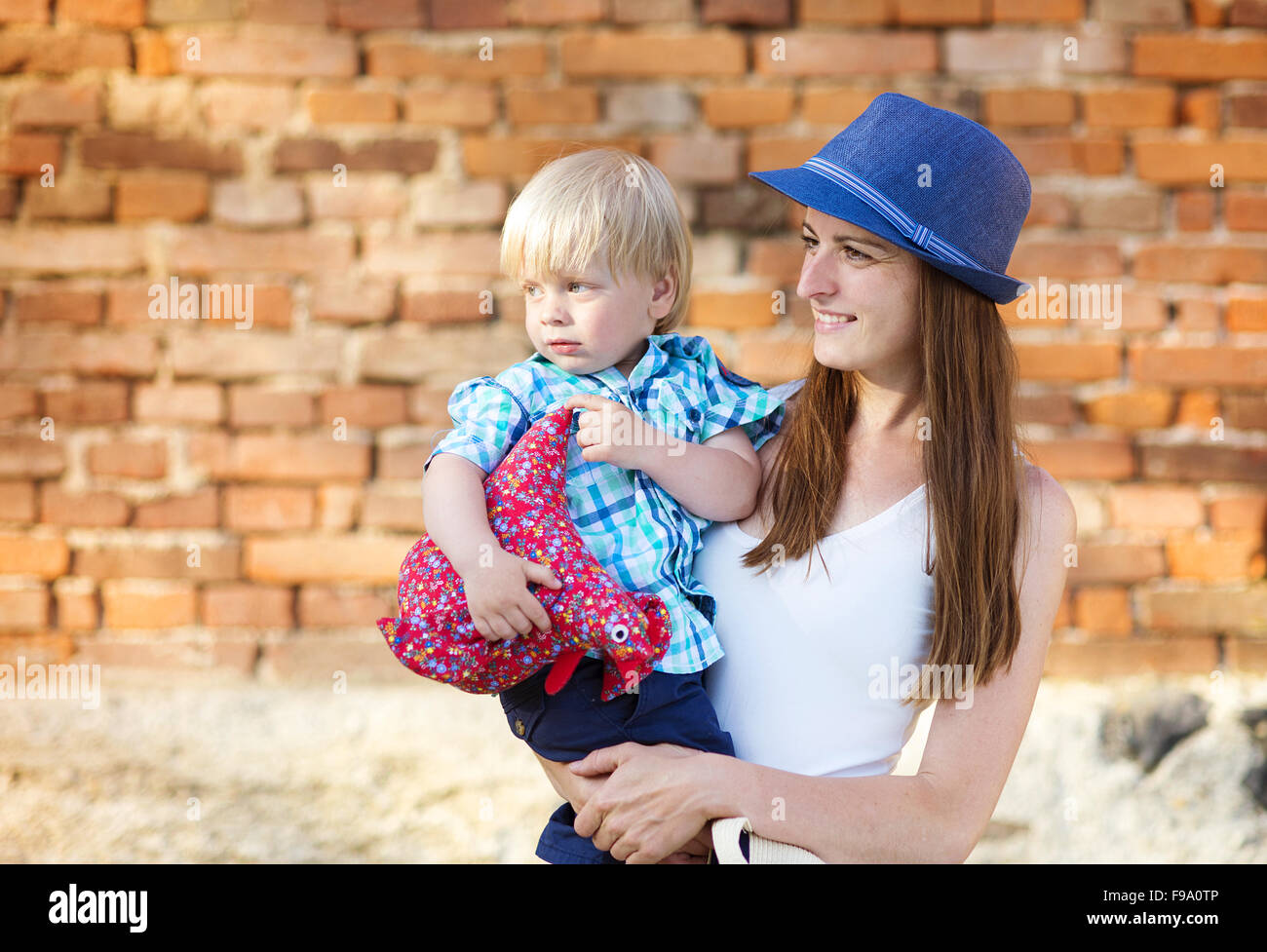 Mother and son hugging by the brick wall in countryside Stock Photo - Alamy