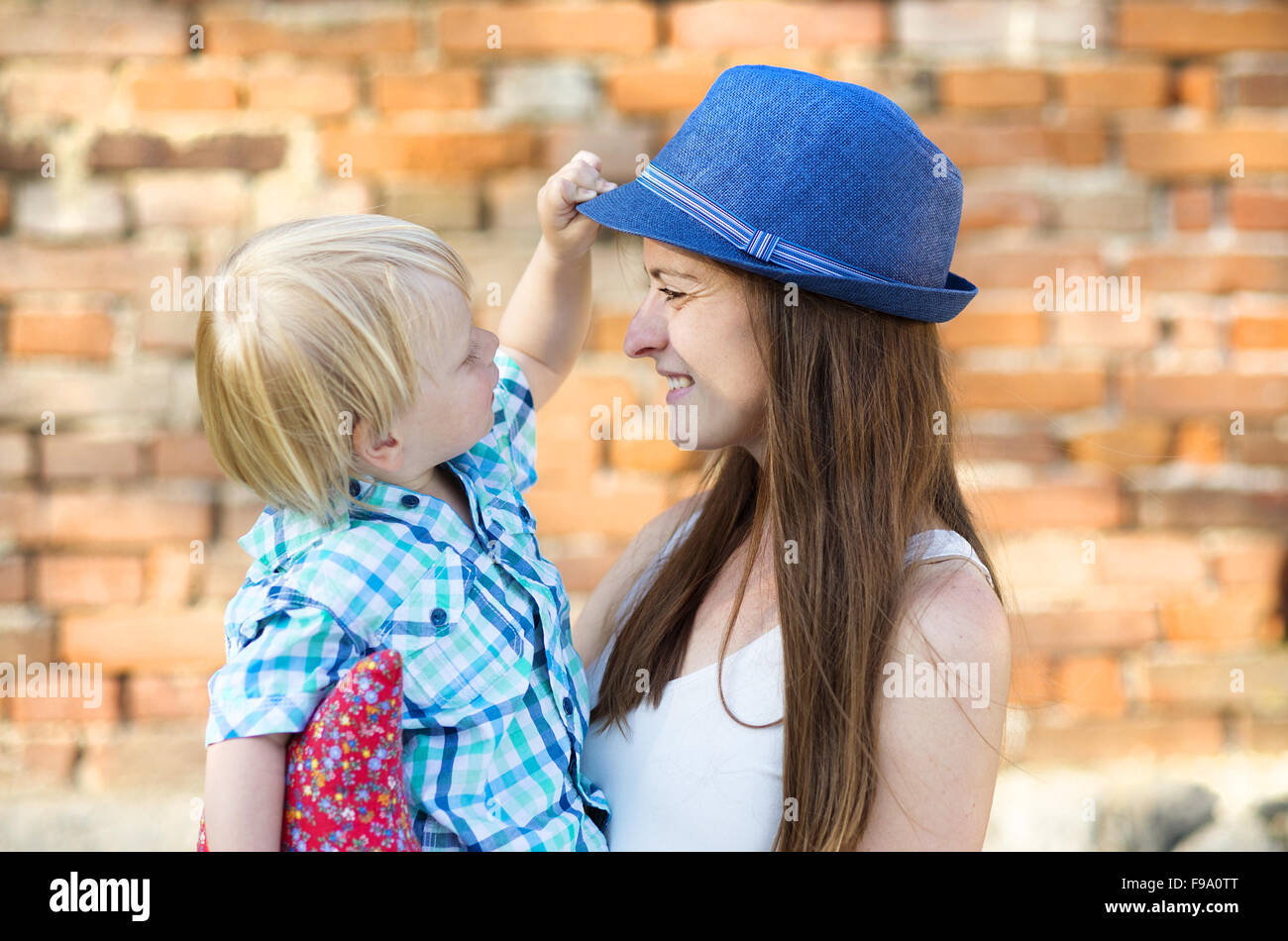 Mother son hugging brick wall hi-res stock photography and images - Alamy