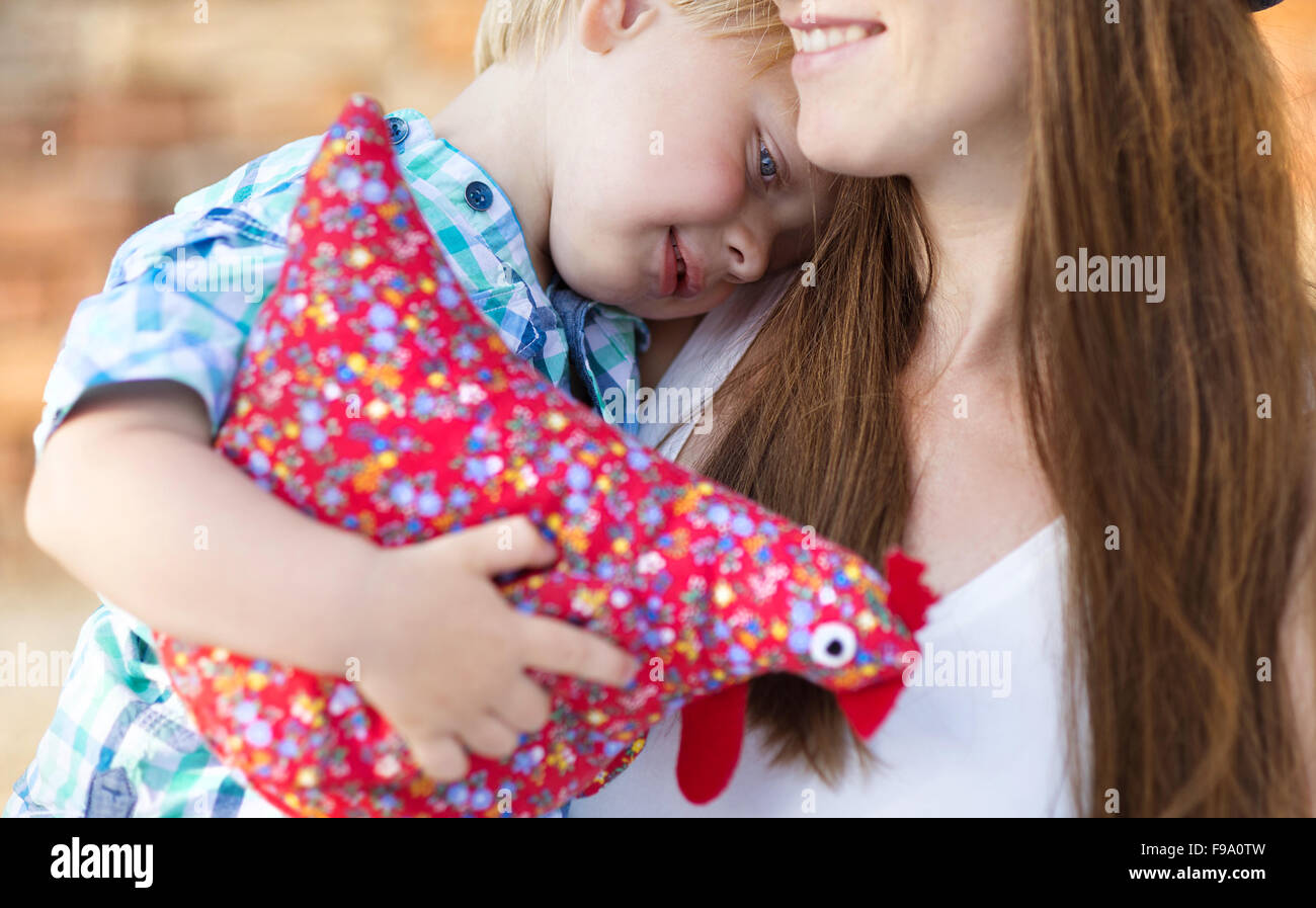 Mother and son hugging by the brick wall in countryside Stock Photo - Alamy