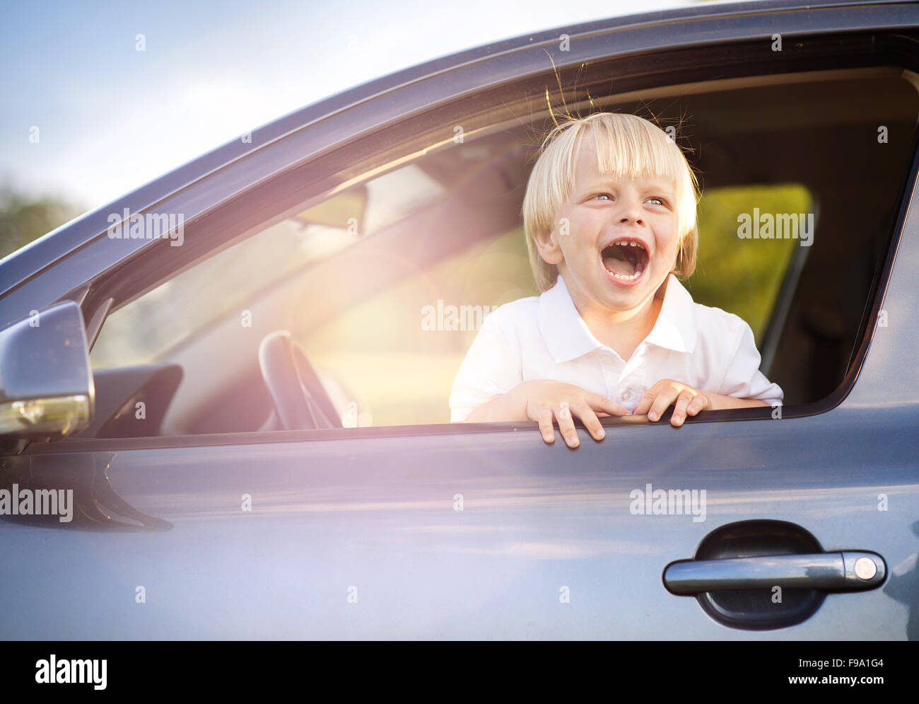 Little boy driving a car. He is having fun Stock Photo - Alamy