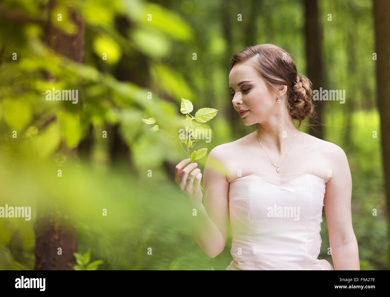 Beautiful bride in veil standing by the old stone chapel Stock Photo ...