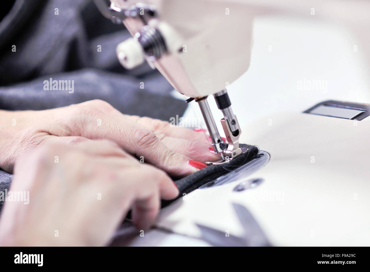 woman Hands of Seamstress Using Sewing Machine tailor and new clothes ...