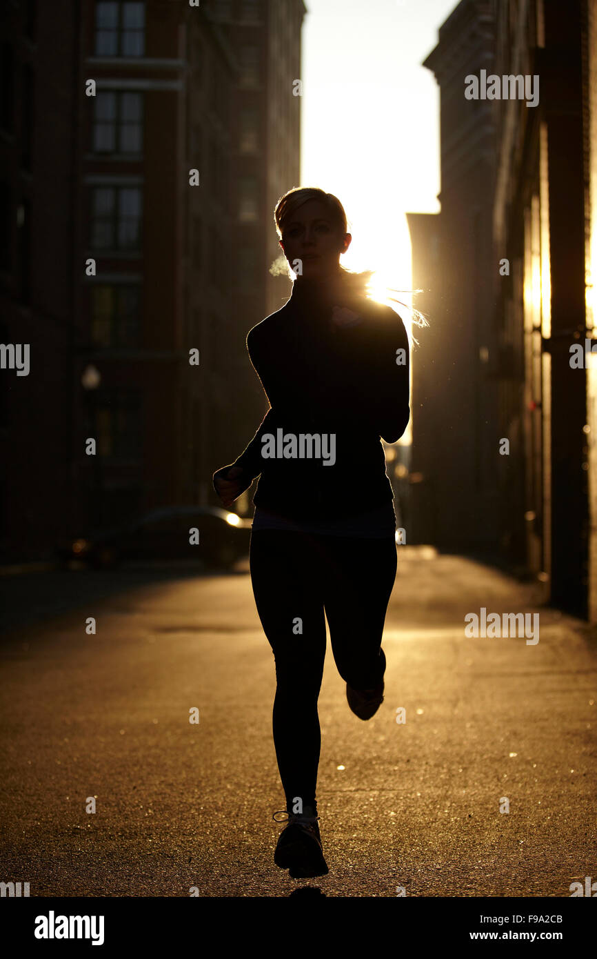 A female athlete running (Back Lit Stock Photo - Alamy