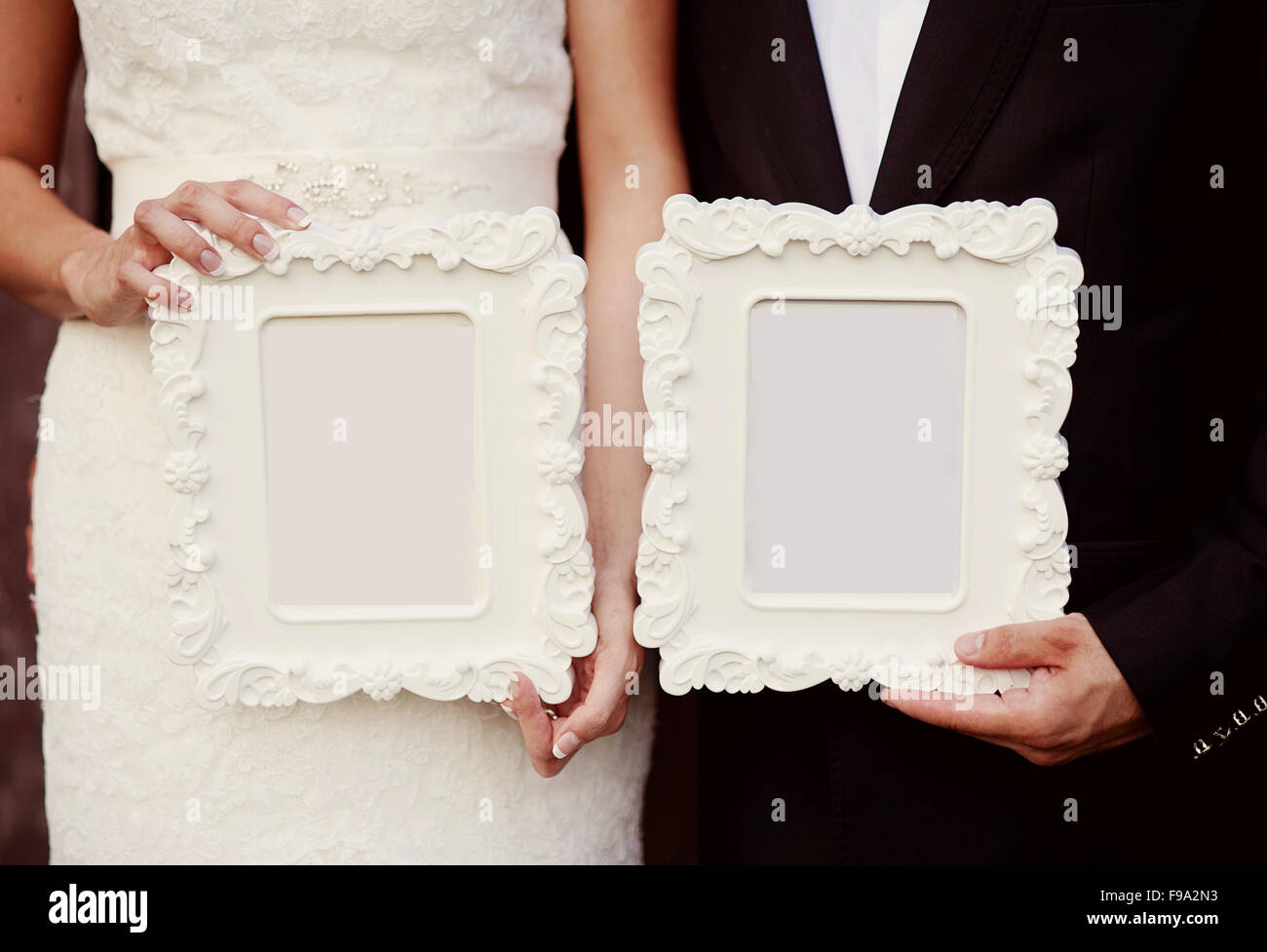 Bride and groom holding vintage photo frames, cut out Stock Photo - Alamy