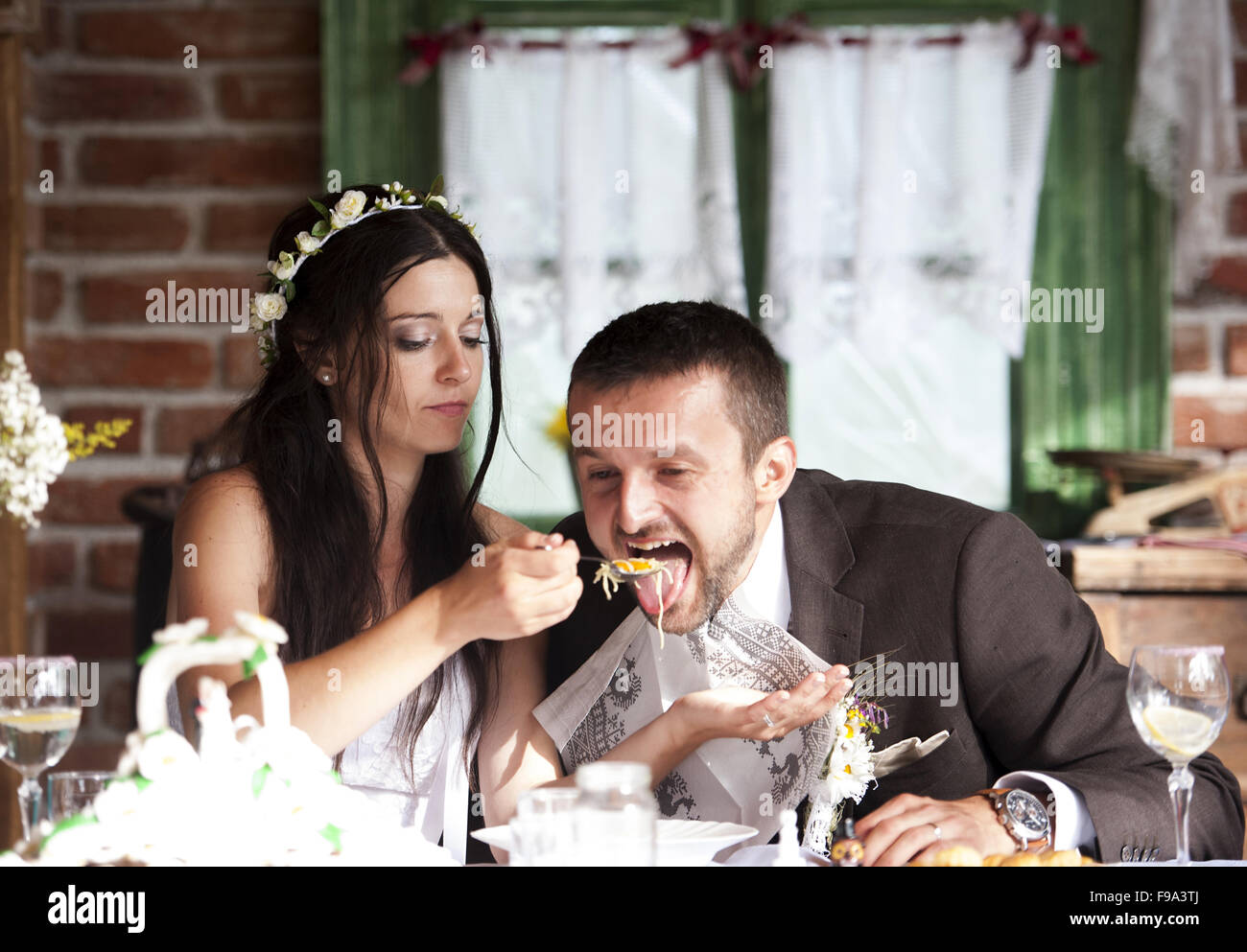 Bride and groom are eating at the wedding reception Stock Photo - Alamy