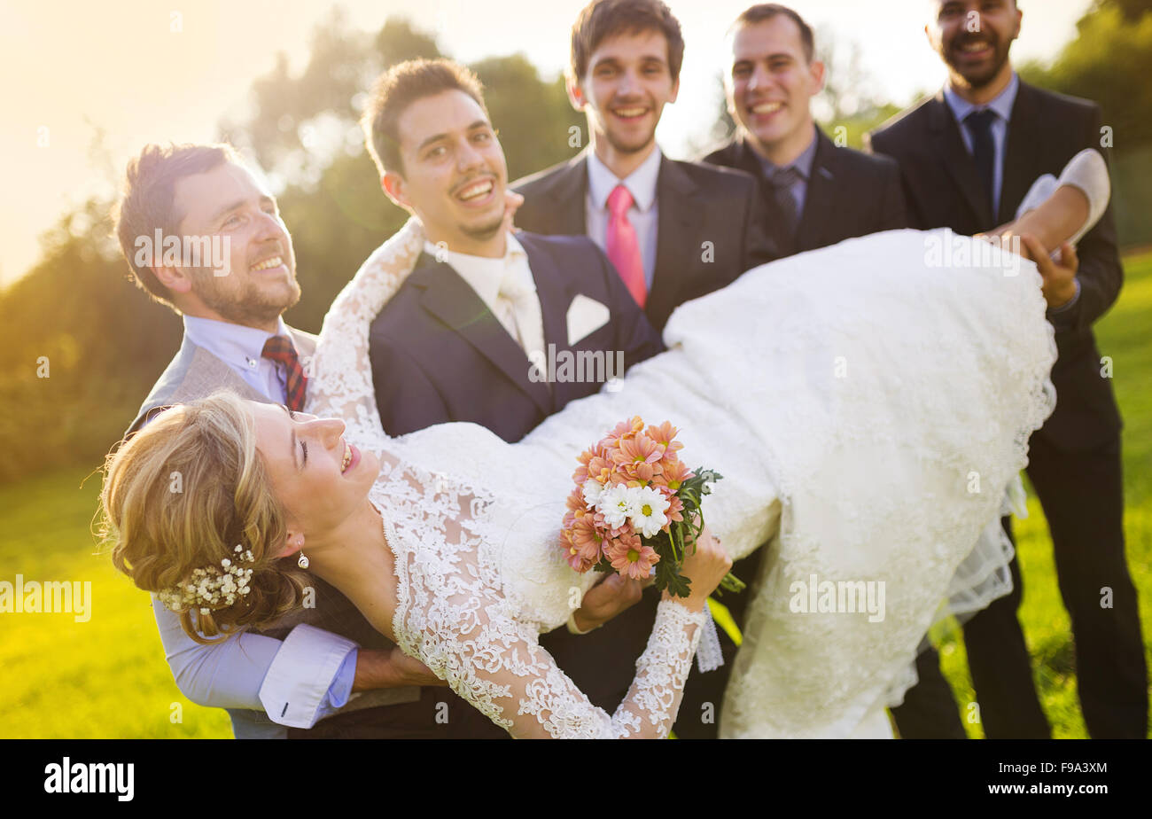 Groomsmen carrying bride hi-res stock photography and images - Alamy