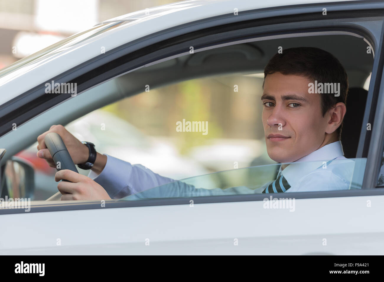 The young man behind the wheel driving car Stock Photo - Alamy