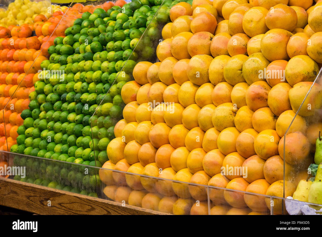 Produce fruit market display of limes, oranges and grapefruit Stock ...