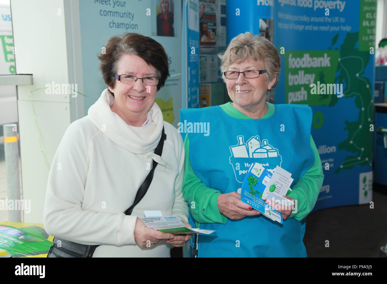charity workers helping out with the foodbank at a local supermarket ...