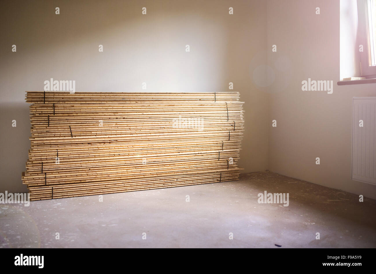 Stack of plywood ready for floor installation in new house Stock Photo ...