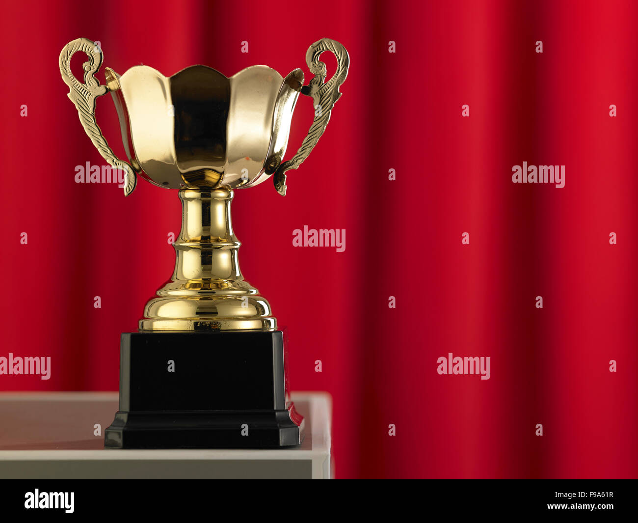 trophy in front of the red curtain Stock Photo - Alamy