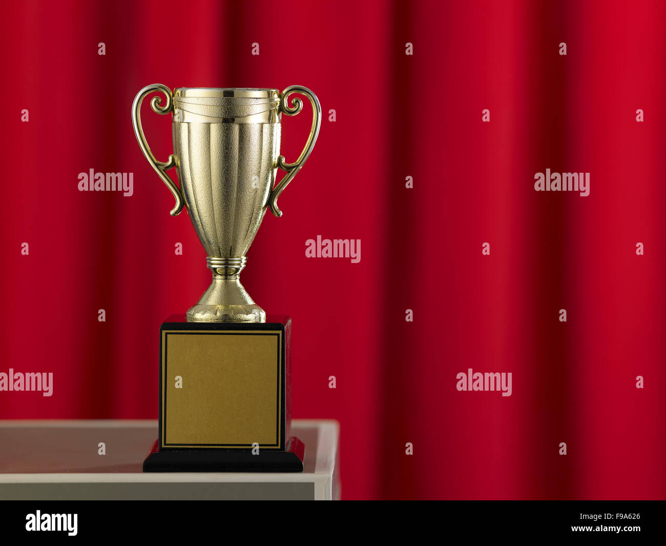 trophy in front of the red curtain Stock Photo - Alamy