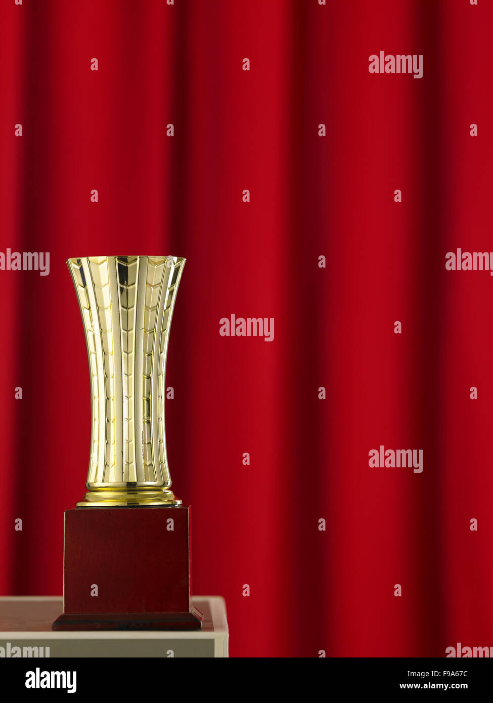 trophy in front of the red curtain Stock Photo - Alamy