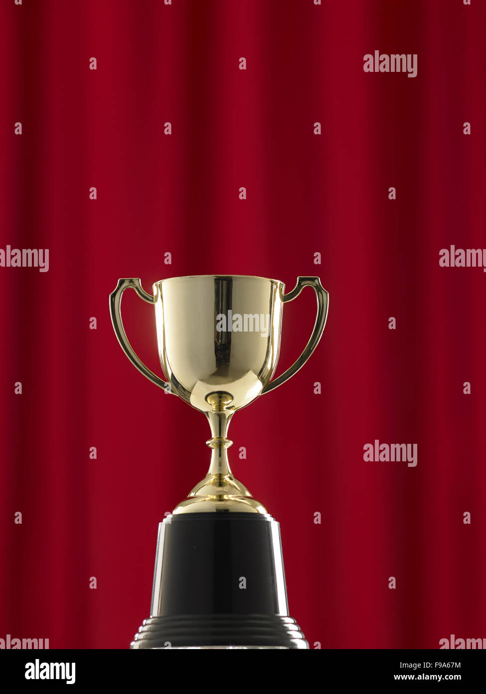 trophy in front of the red curtain Stock Photo - Alamy