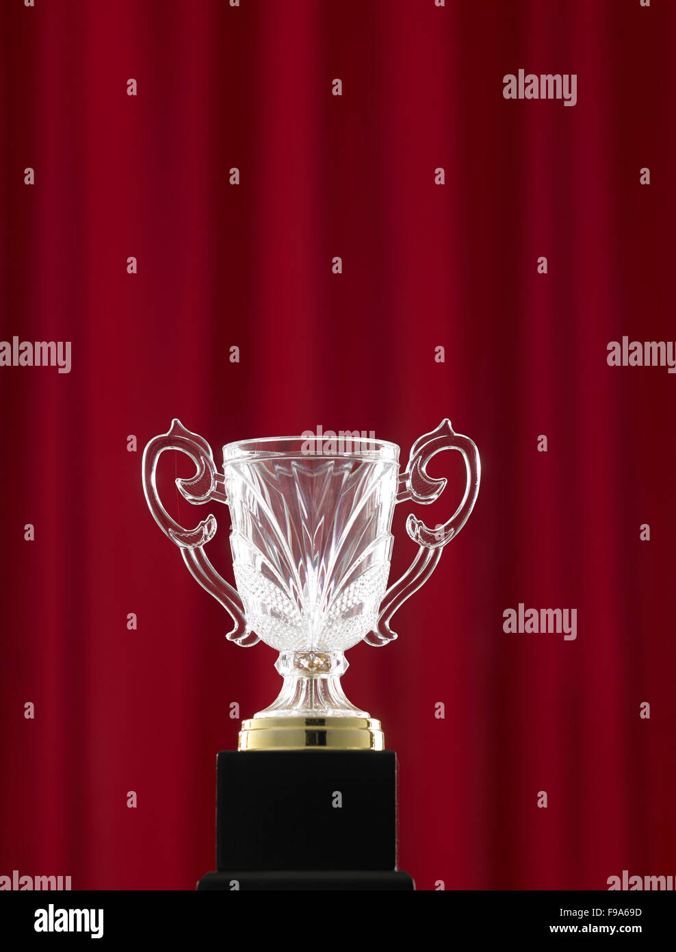 trophy in front of the red curtain Stock Photo - Alamy