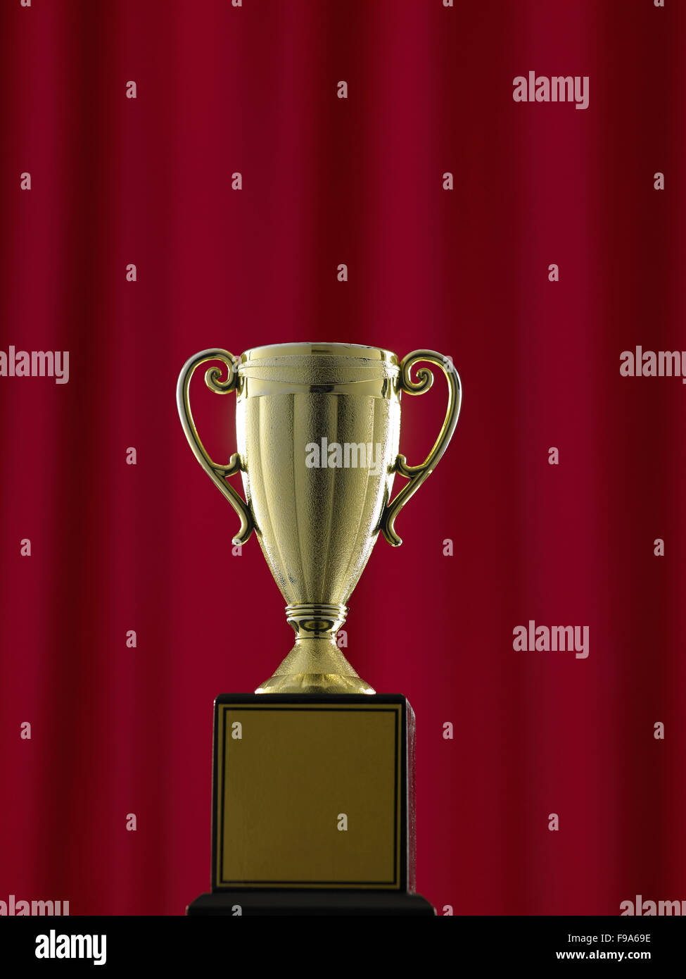 trophy in front of the red curtain Stock Photo - Alamy