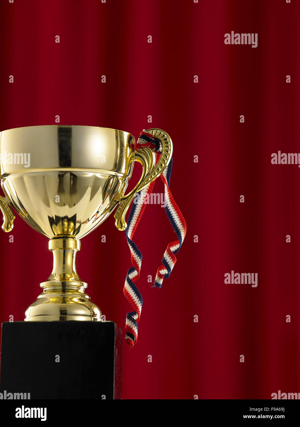 trophy in front of the red curtain Stock Photo - Alamy