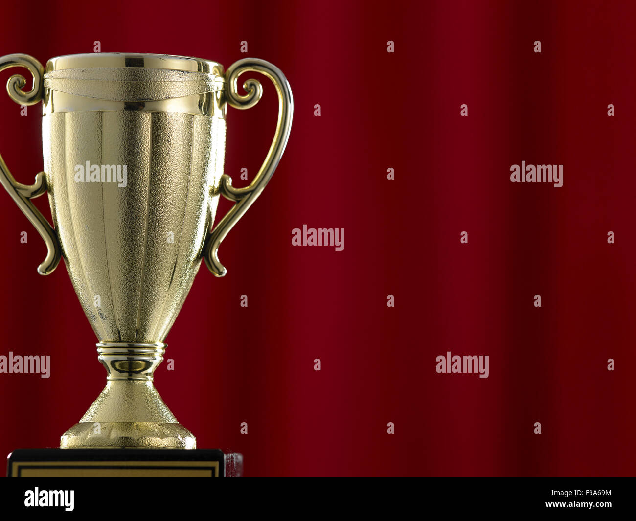 trophy in front of the red curtain Stock Photo - Alamy
