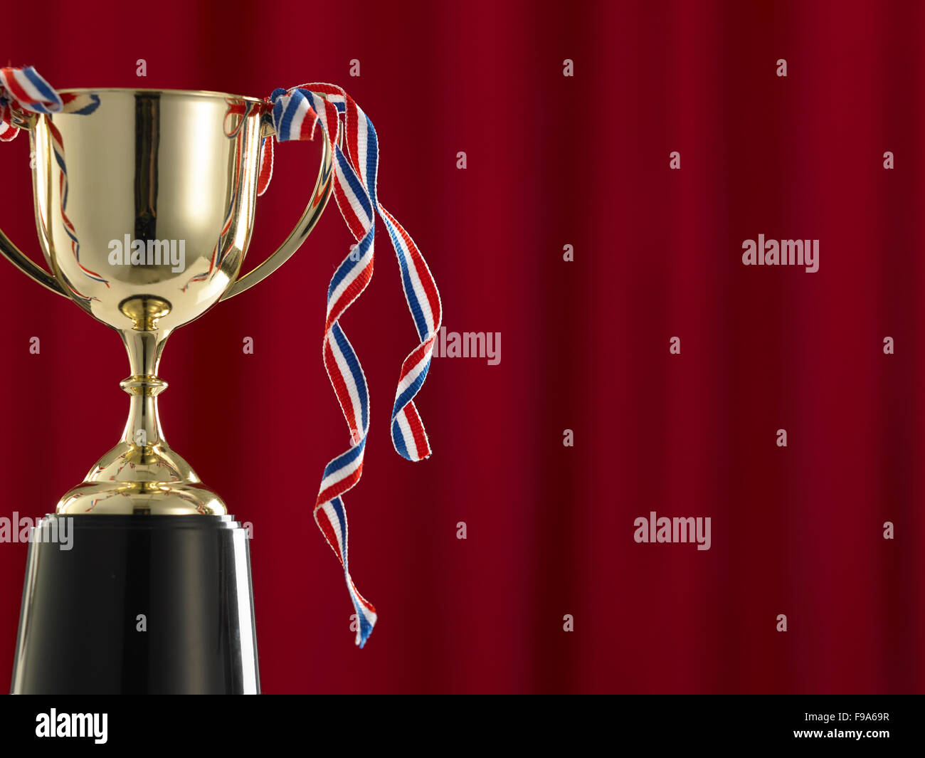 trophy in front of the red curtain Stock Photo - Alamy