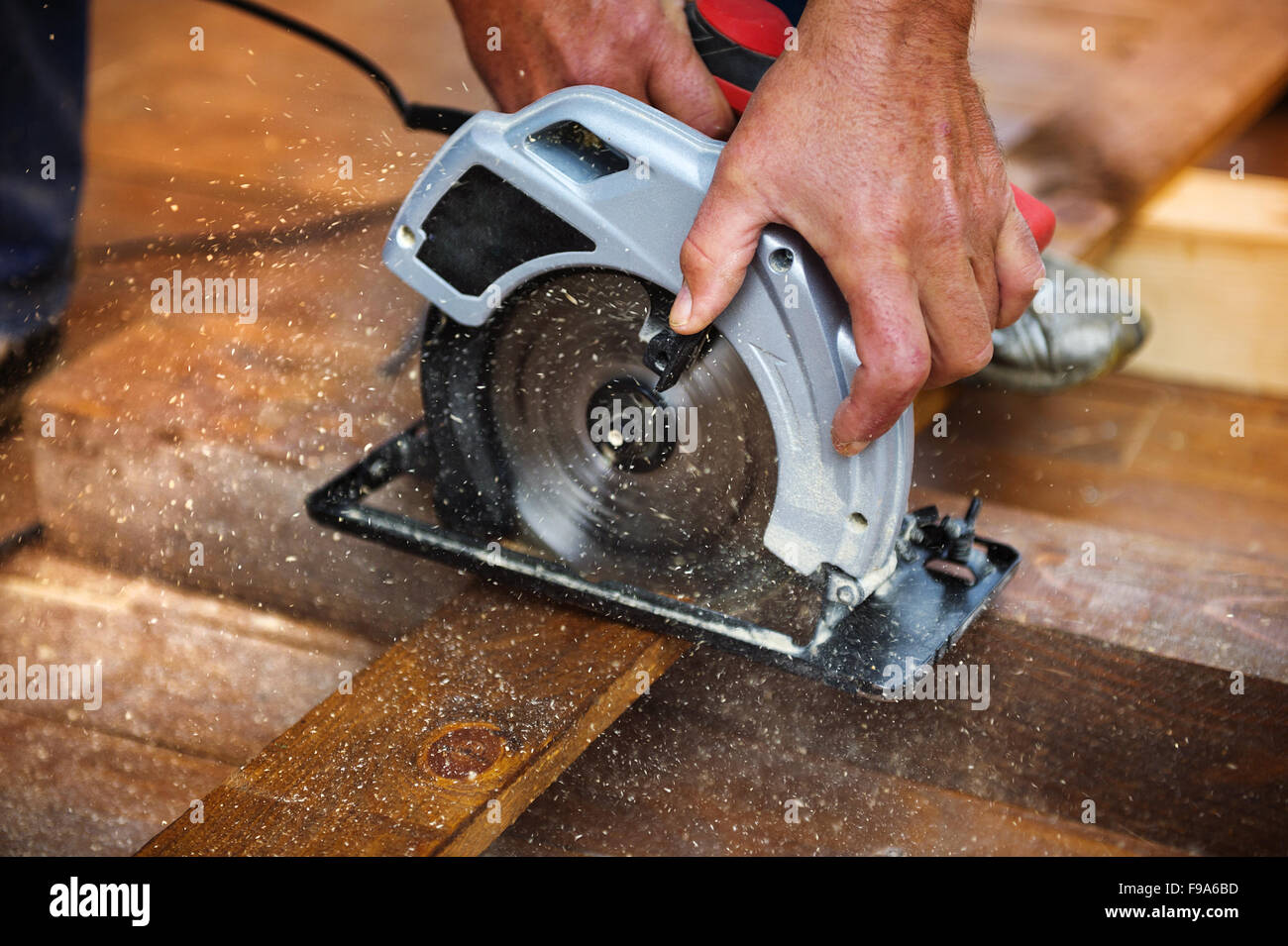 Detail of carpenters hand grinding wooden planks Stock Photo - Alamy