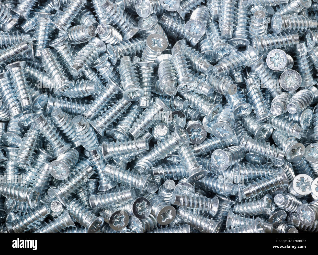 full frame background showing lots of short screws Stock Photo - Alamy