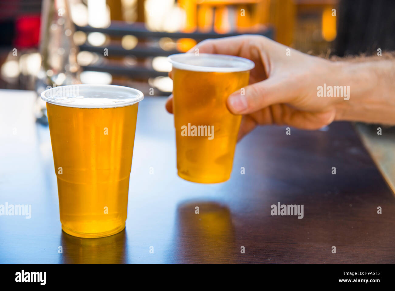 Two glasses of beer and man's hand holding one of them Stock Photo - Alamy
