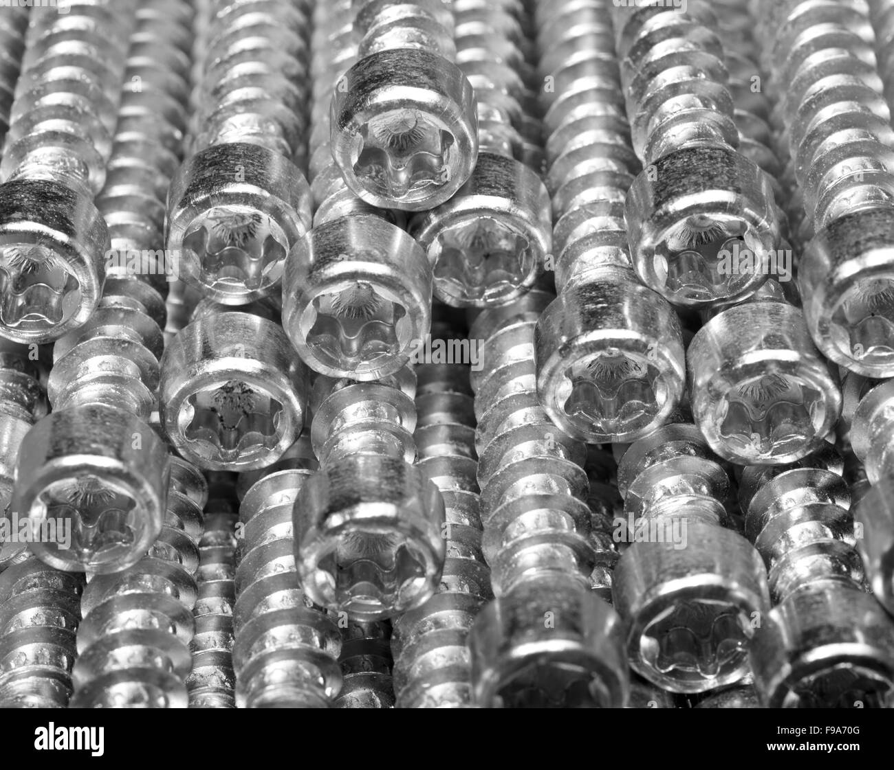full frame background showing lots of long screws Stock Photo - Alamy
