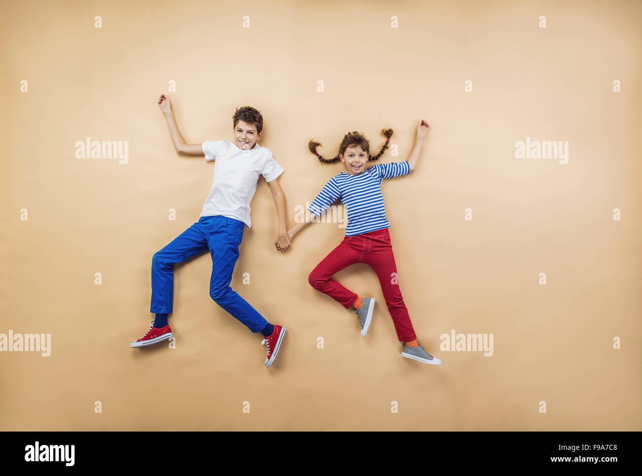 Funny children playing together lying hi-res stock photography and ...