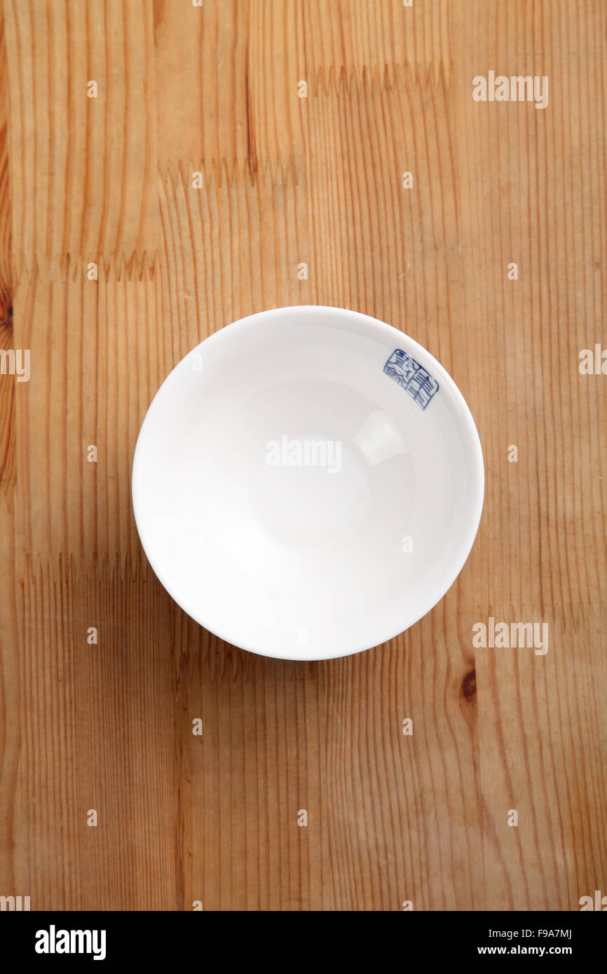 empty chinese rice bowl on a wooden background Stock Photo - Alamy