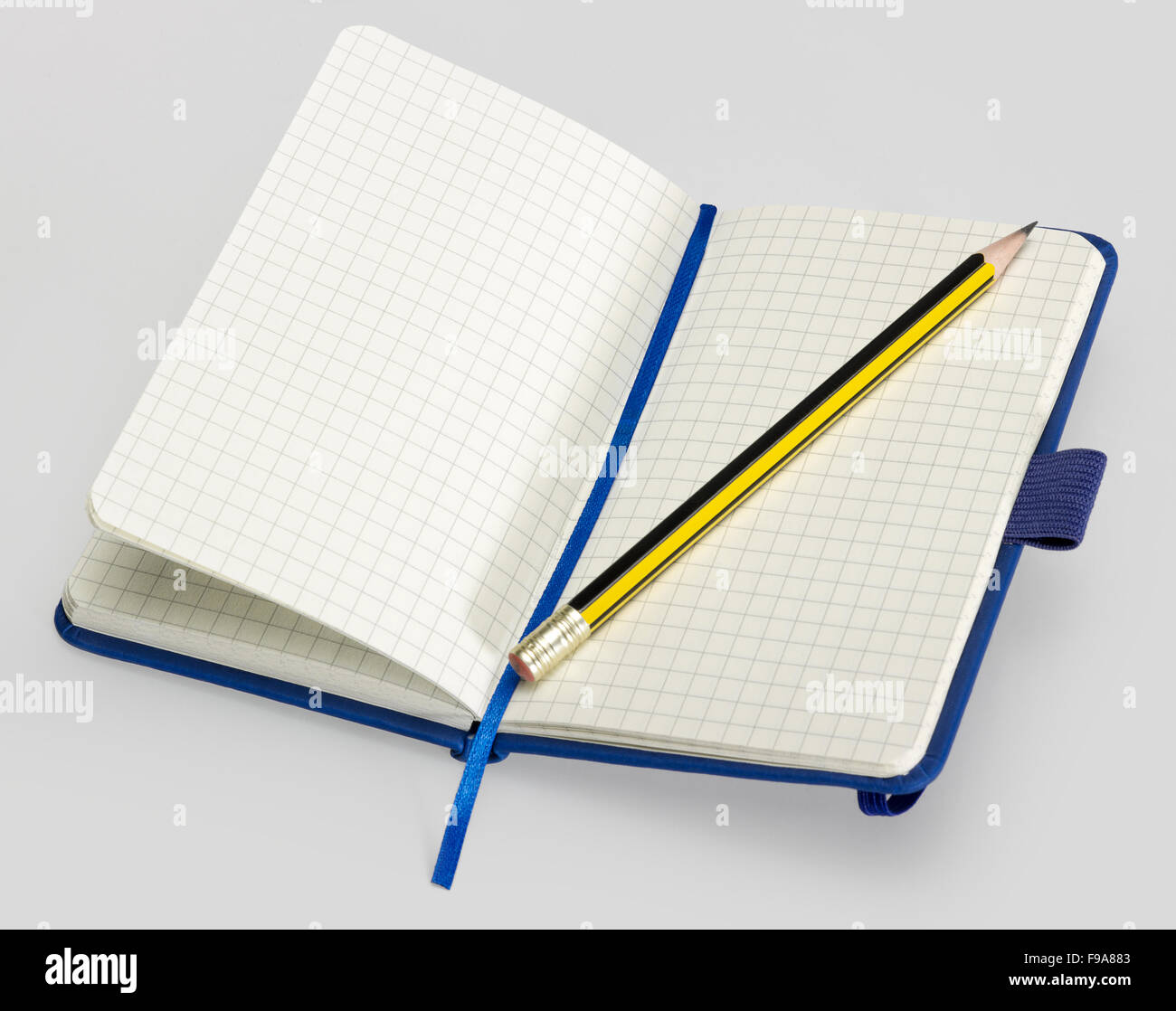 a open notebook and pencil in light back Stock Photo - Alamy