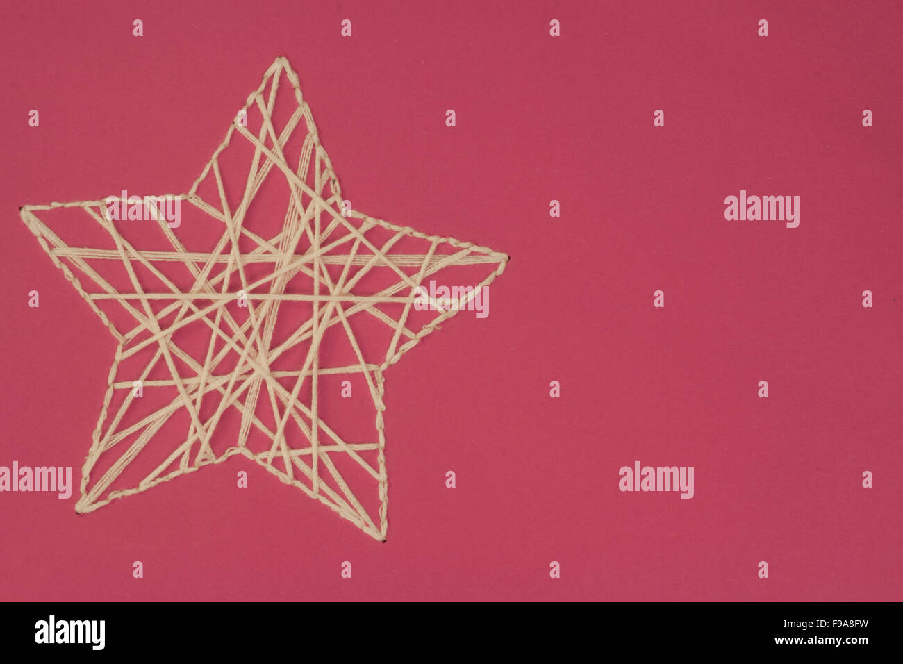 a horizontal overhead view of a handmade star made by string with space ...