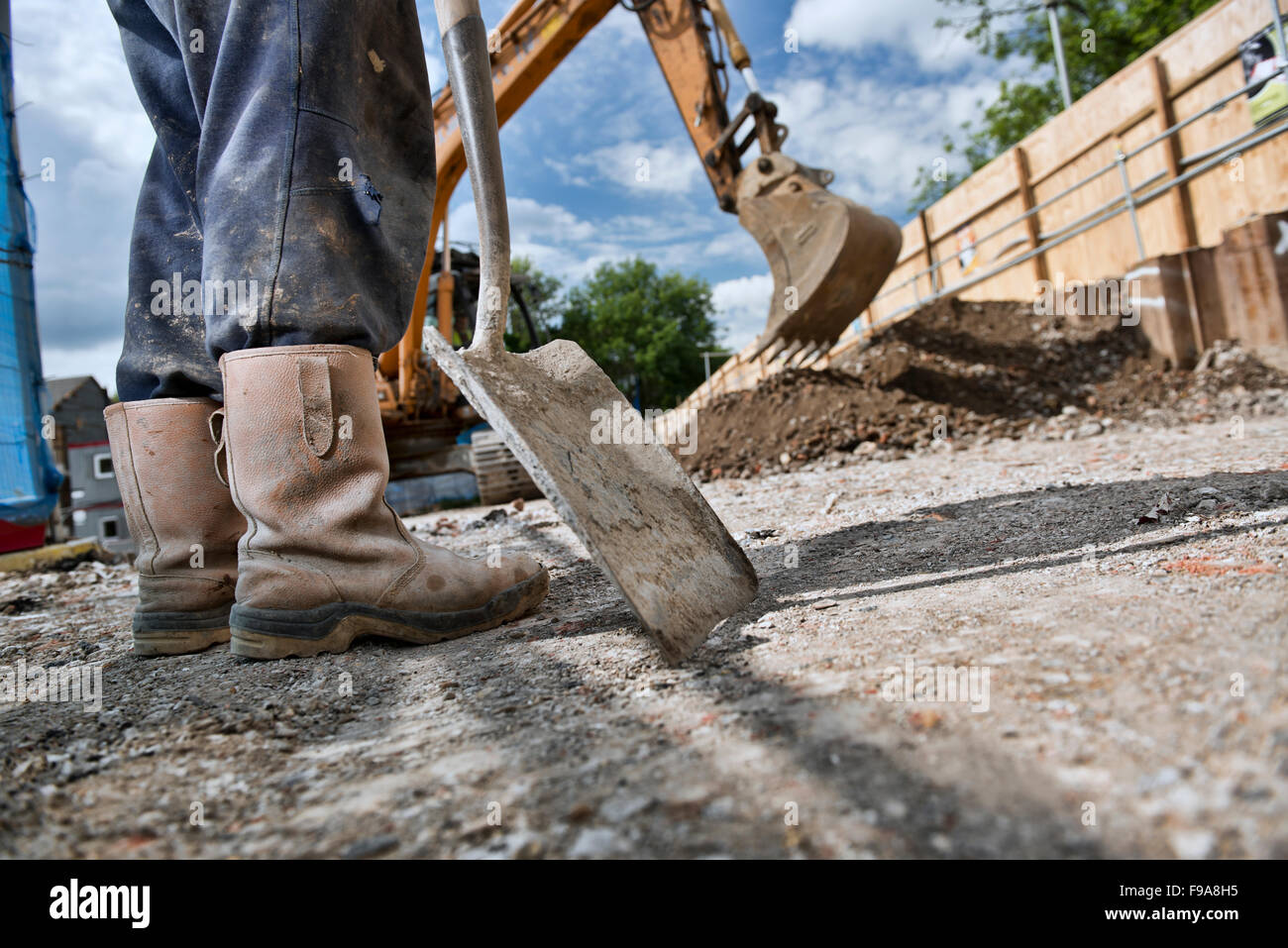 Workers legs and shovel on a construction site Stock Photo - Alamy