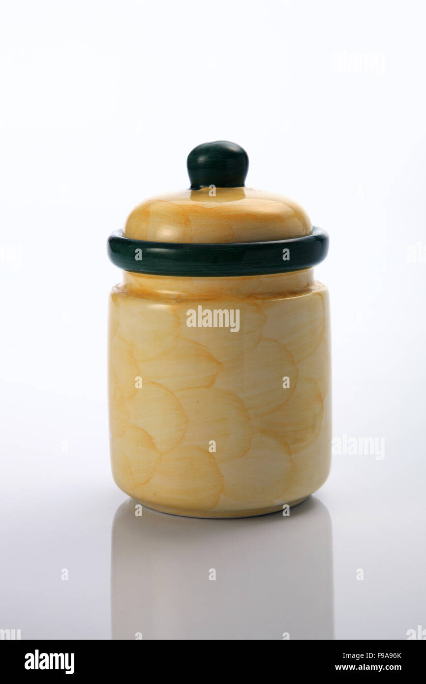 yellow color porcelain jar on the white background Stock Photo - Alamy